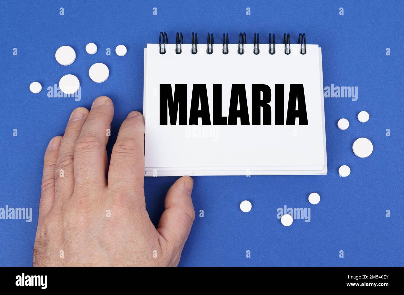 Medical concept. On the blue surface of the tablet, a hand and a ...