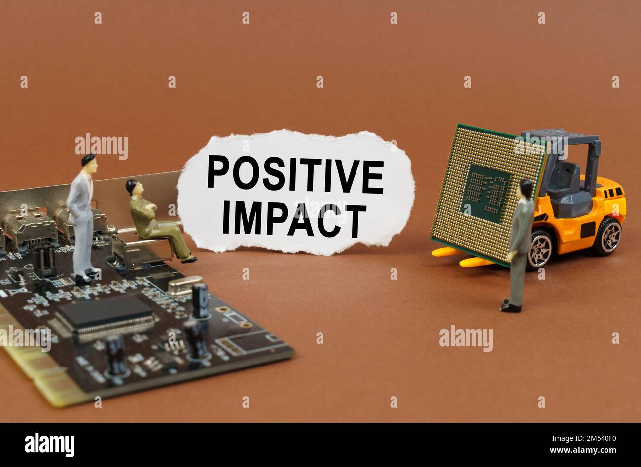 Technology and business concept. On a brown surface, a loader with a ...