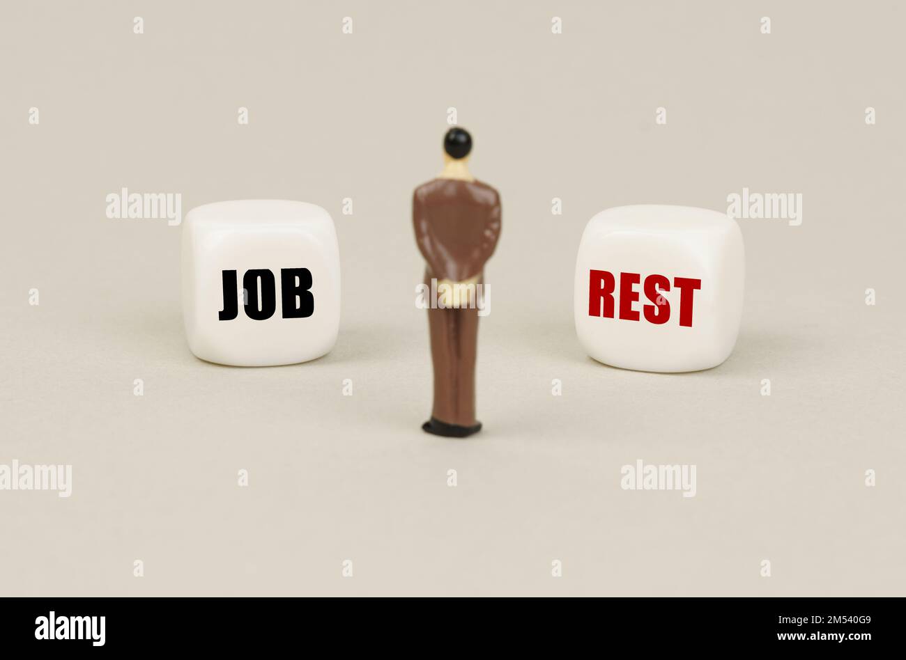 Business concept. A human figurine stands in front of white cubes with ...