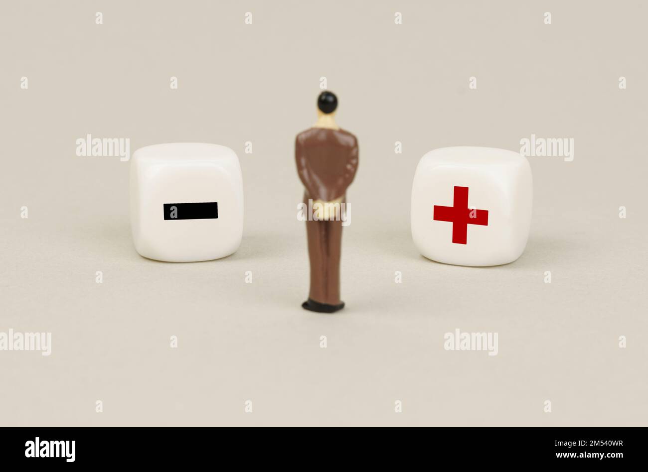 People concept. A human figurine stands in front of white cubes with ...