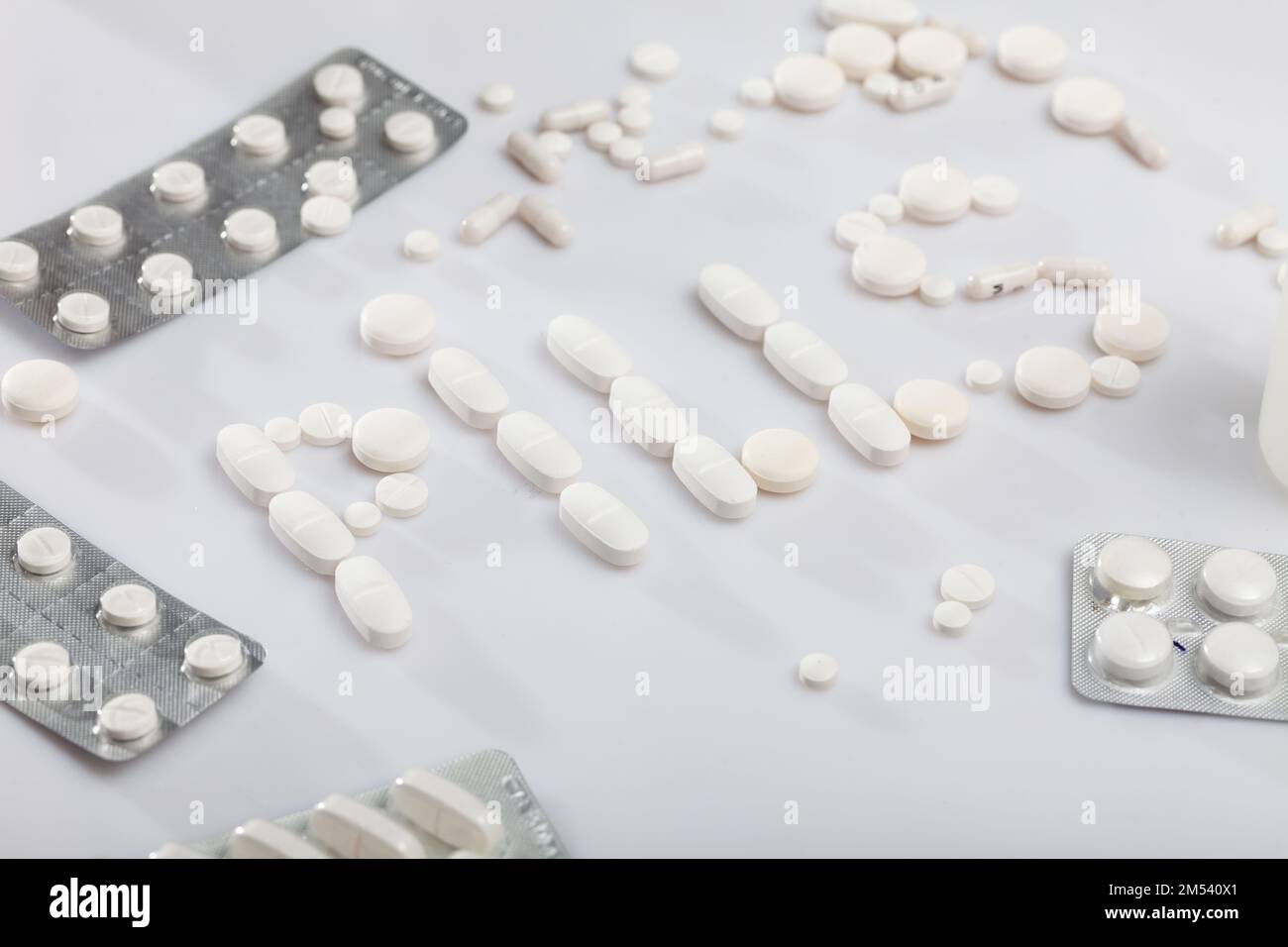 Word PILLS lined with tablets Stock Photo - Alamy