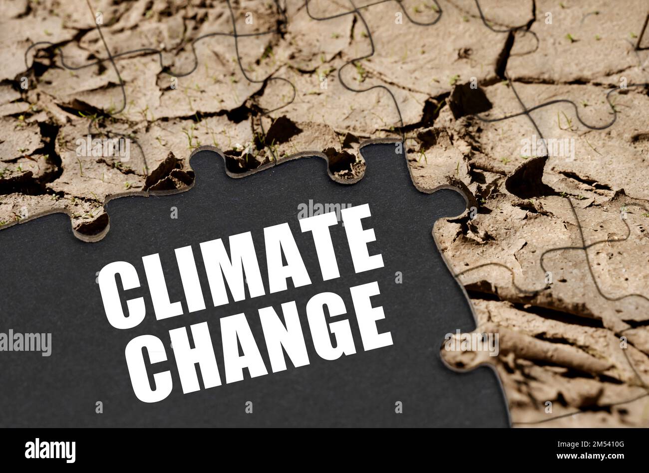 Ecological concept. The puzzles depict soil, next to a black surface ...