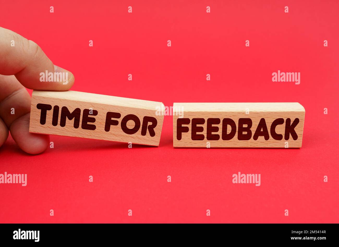 Business concept. On a red background, wooden blocks, one of them in ...