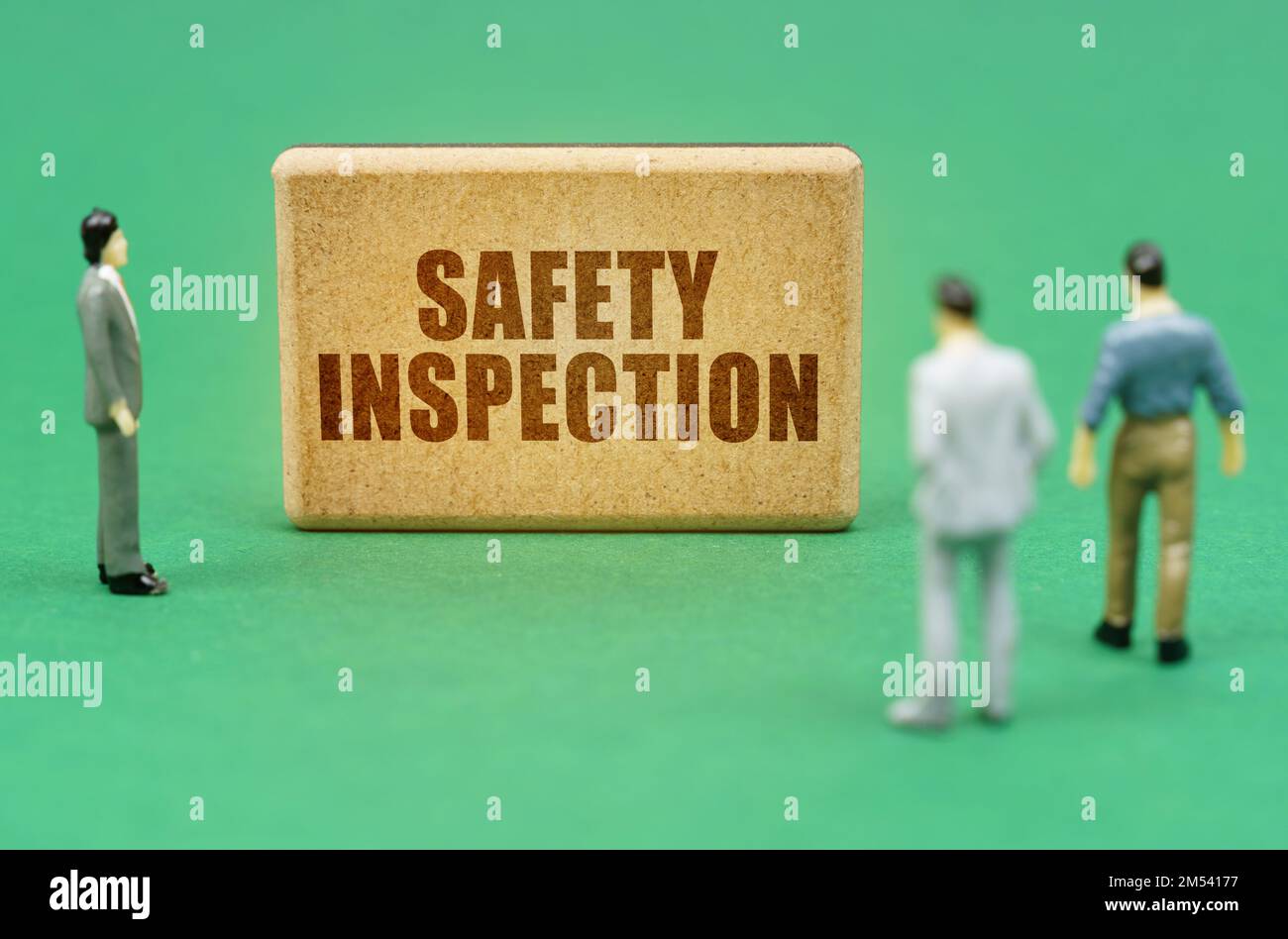 Security and insurance concept. On the green surface are figures of ...