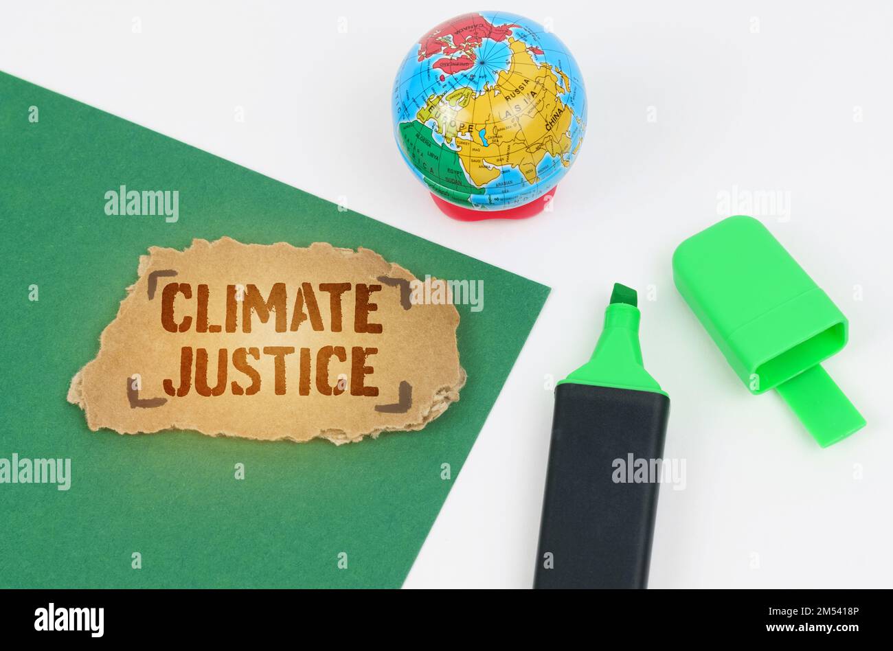 Ecological and industrial concept. On the table is a globe and a marker ...