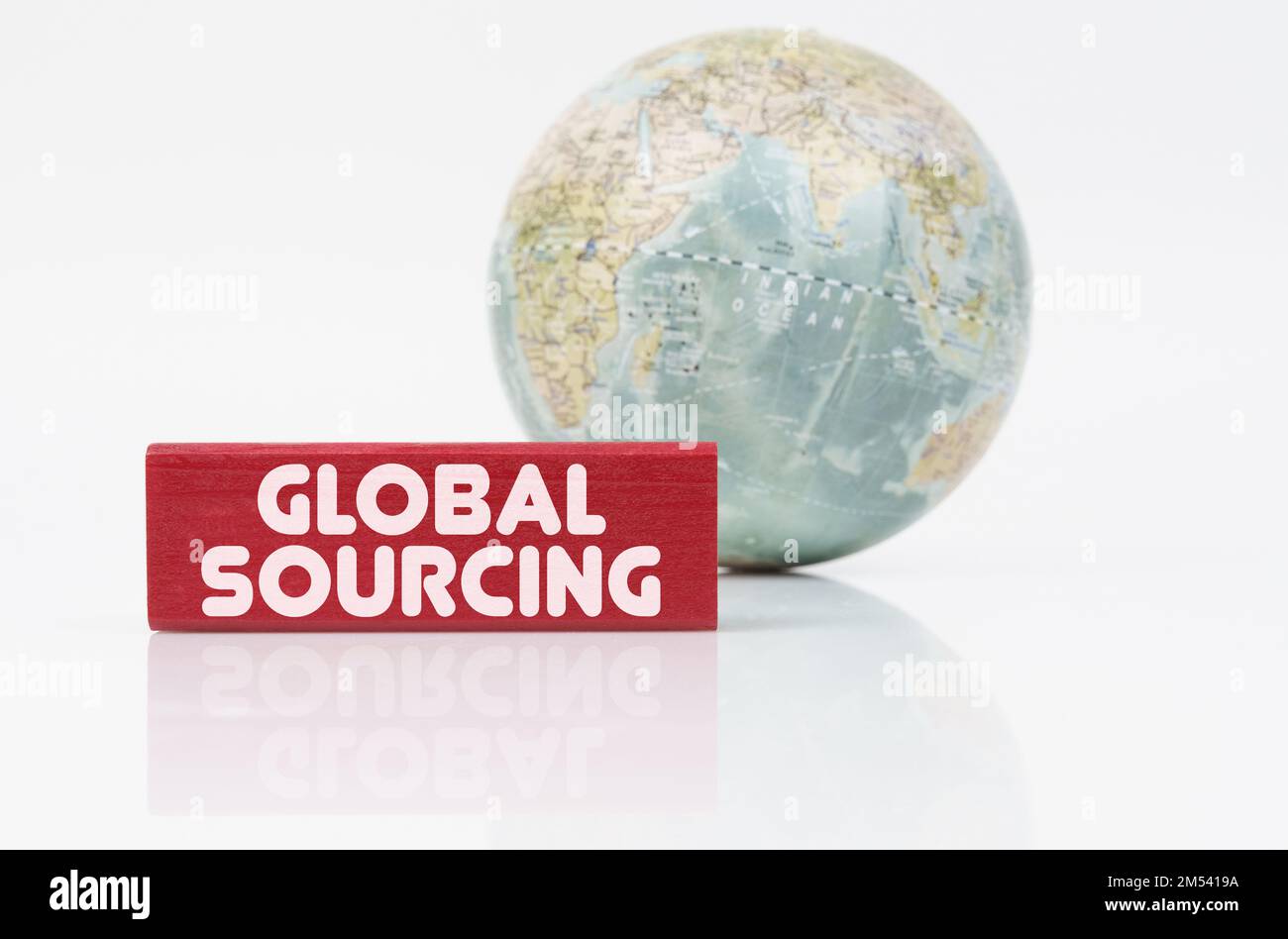 Business and technology concept. Near the globe is a red plaque with ...