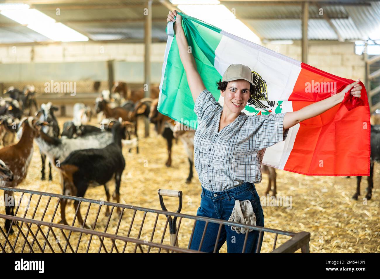 Happy young Latin female traveler waving Mexican flag inside of ...