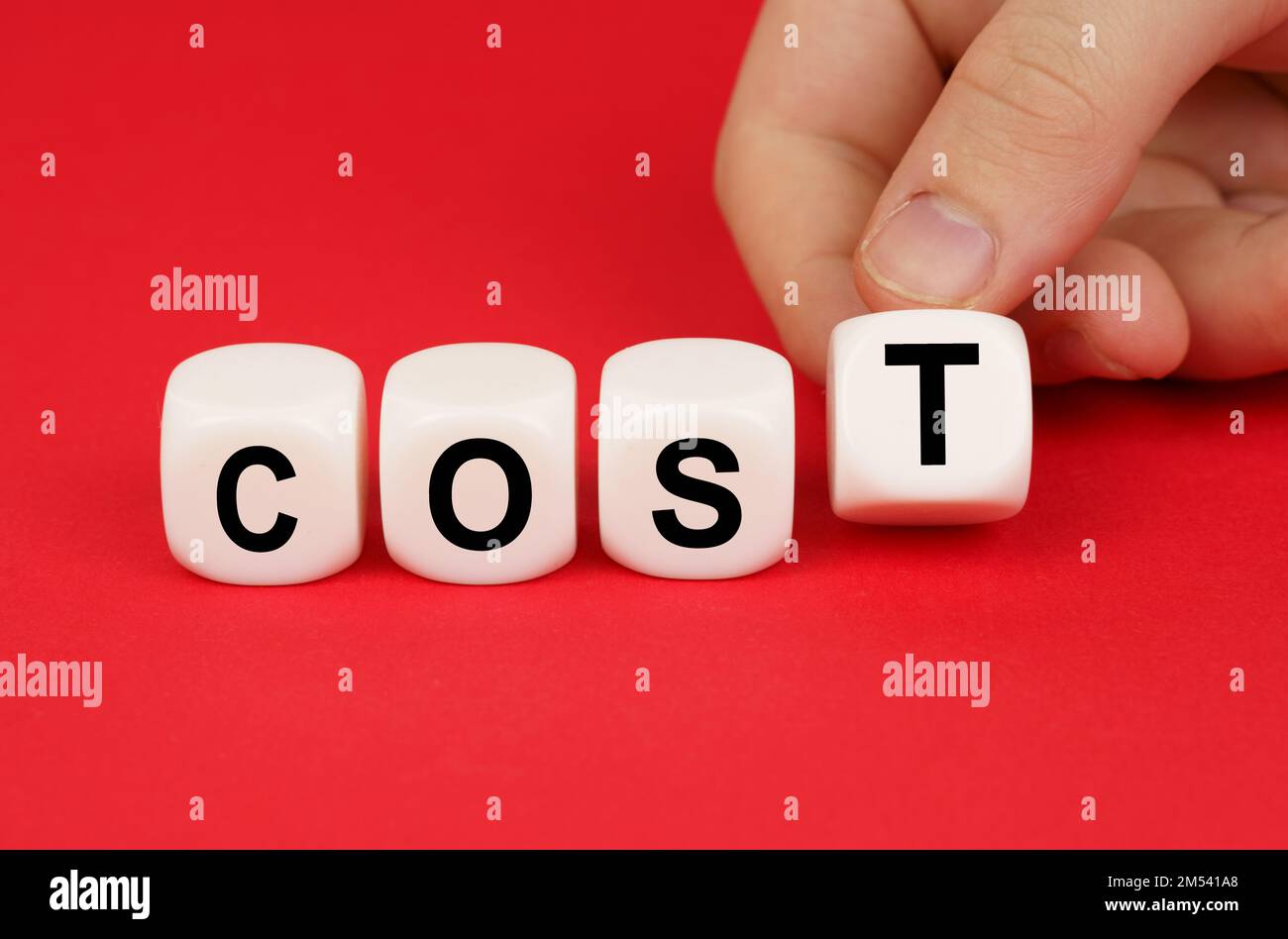 Business concept. On a red background, a person's hand moves the cubes ...