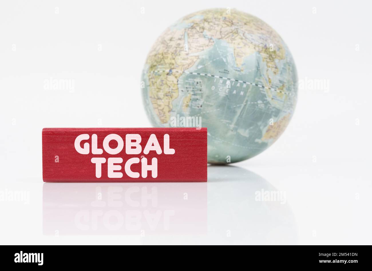 Business and technology concept. Near the globe is a red plaque with ...