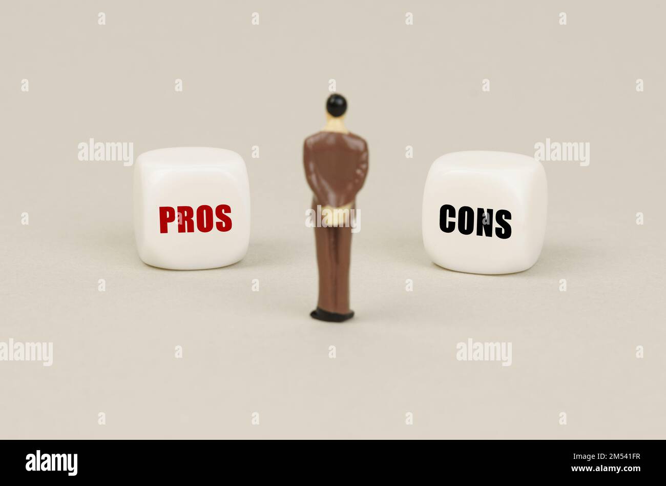 Business concept. A human figurine stands in front of white cubes with ...