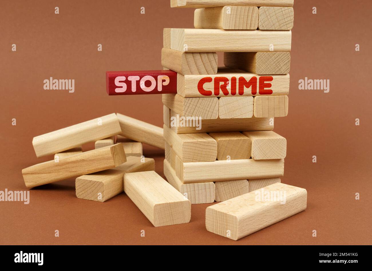 Criminal concept. There is a wooden tower on a brown surface. On the ...