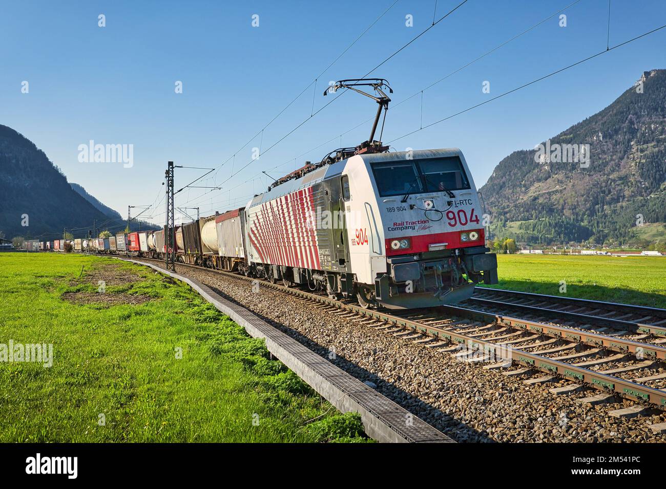 A beautiful view of a modern locomotive with a freight train during ...