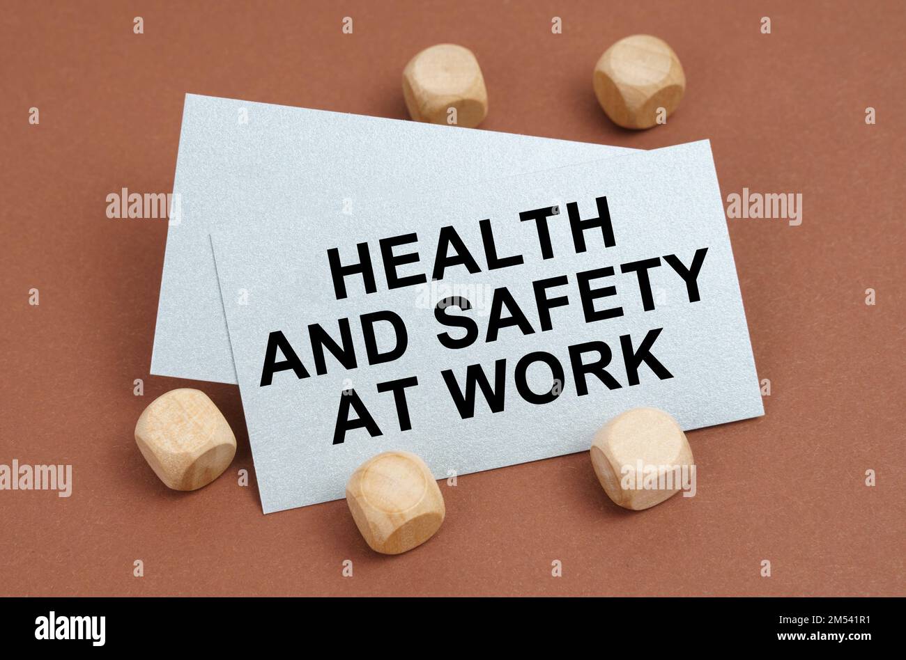 The concept of industrial safety. On a brown surface, wooden cubes and ...