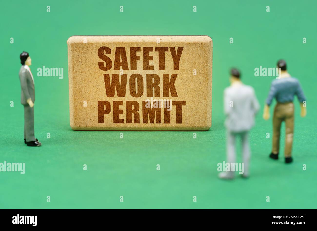 Security and insurance concept. On the green surface are figures of ...