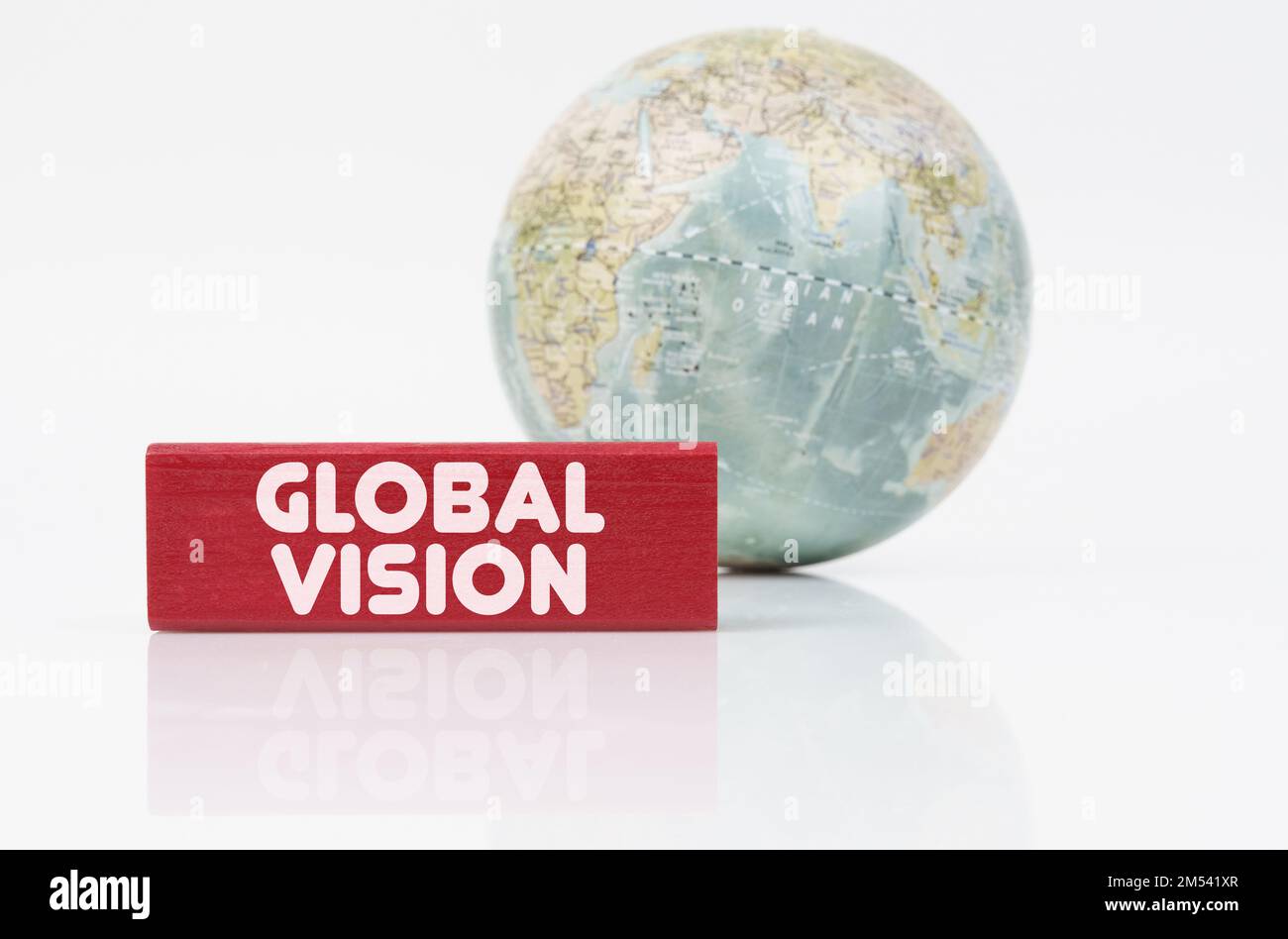 Business and technology concept. Near the globe is a red plaque with ...