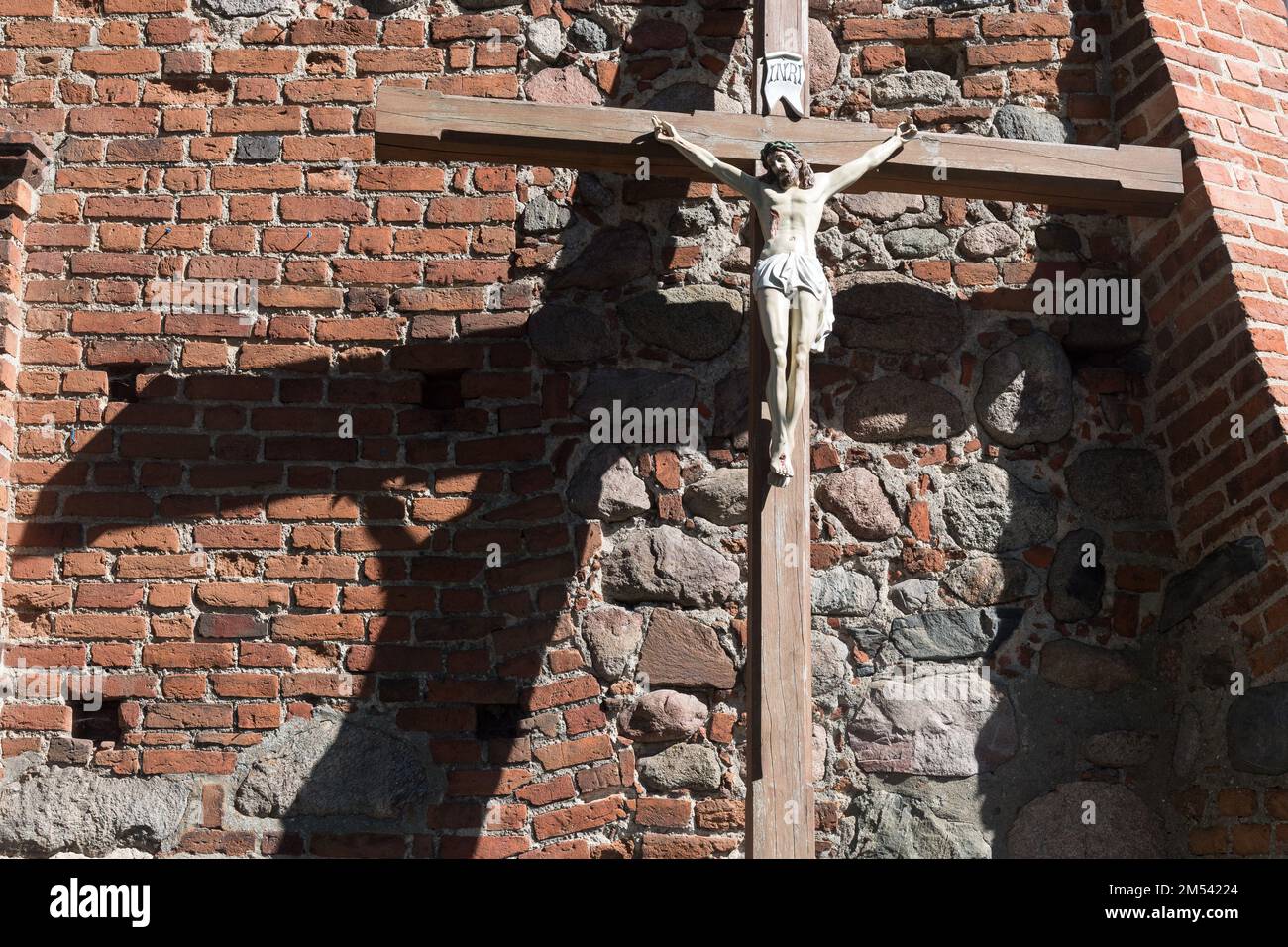Cross in front of gothic The Feast of the Cross church in Lisewo ...