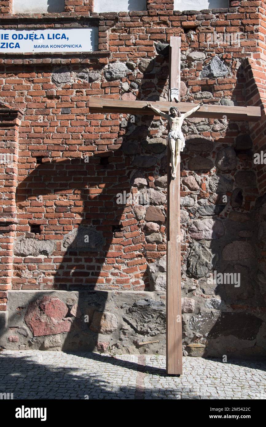 Cross in front of gothic The Feast of the Cross church in Lisewo ...