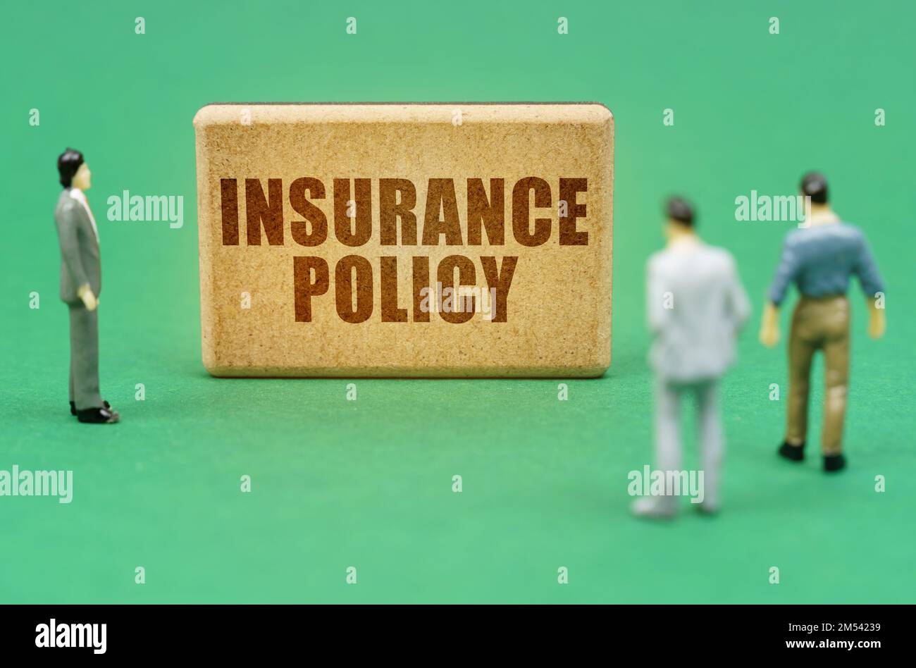 Security and insurance concept. On the green surface are figures of ...
