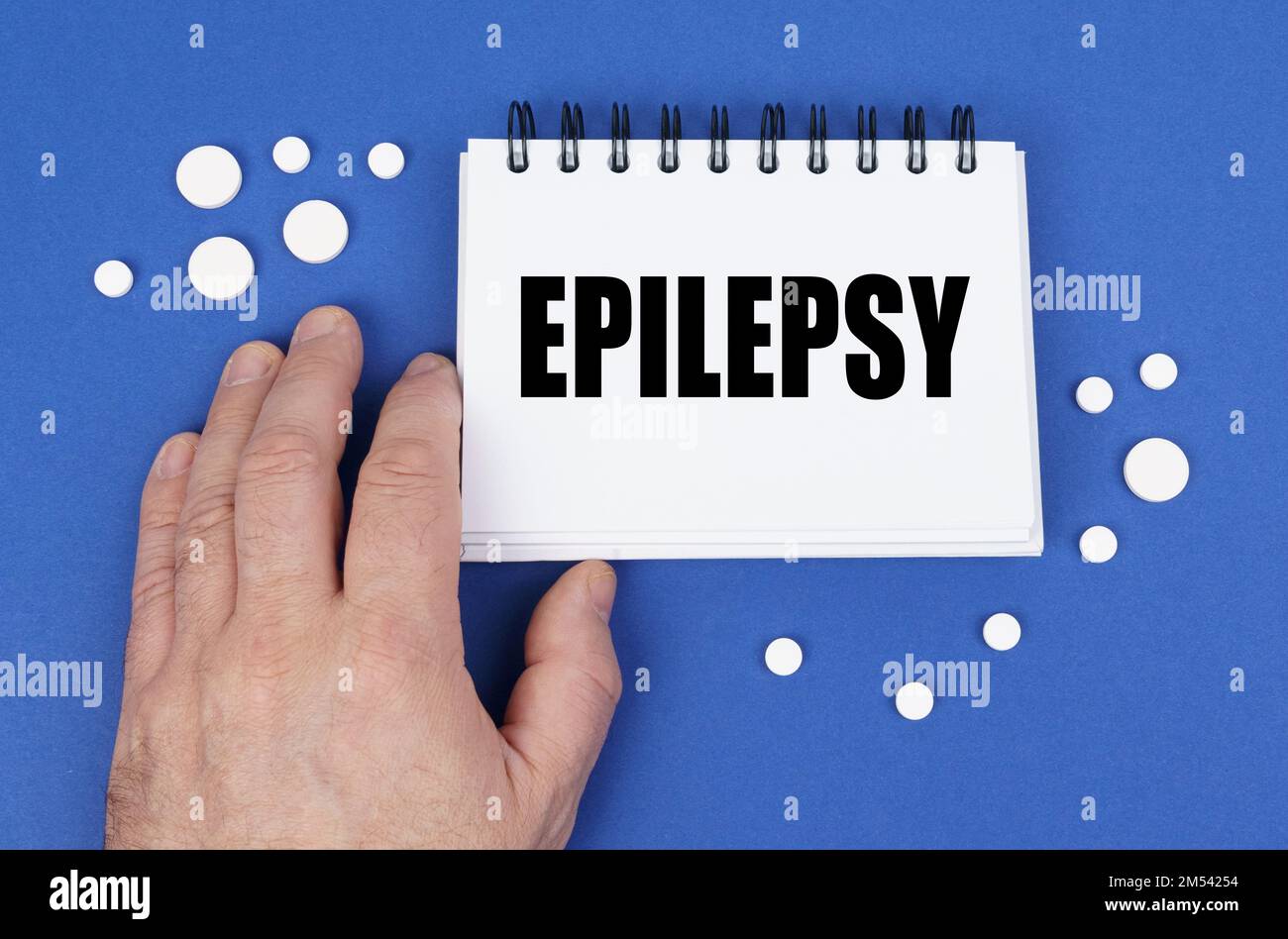 Medical concept. On the blue surface of the tablet, a hand and a ...