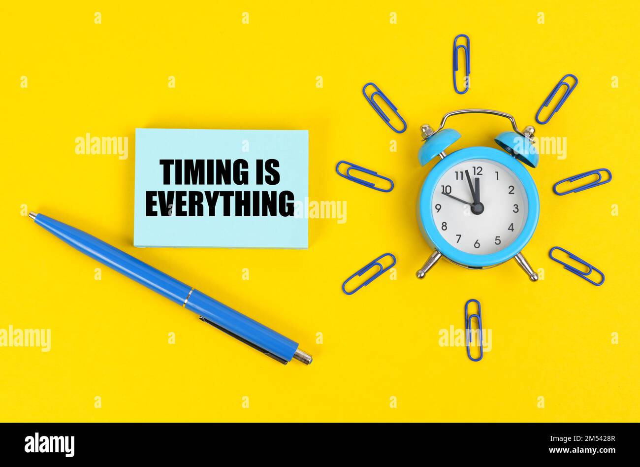 Business concept. On the yellow surface there is an alarm clock, a pen ...