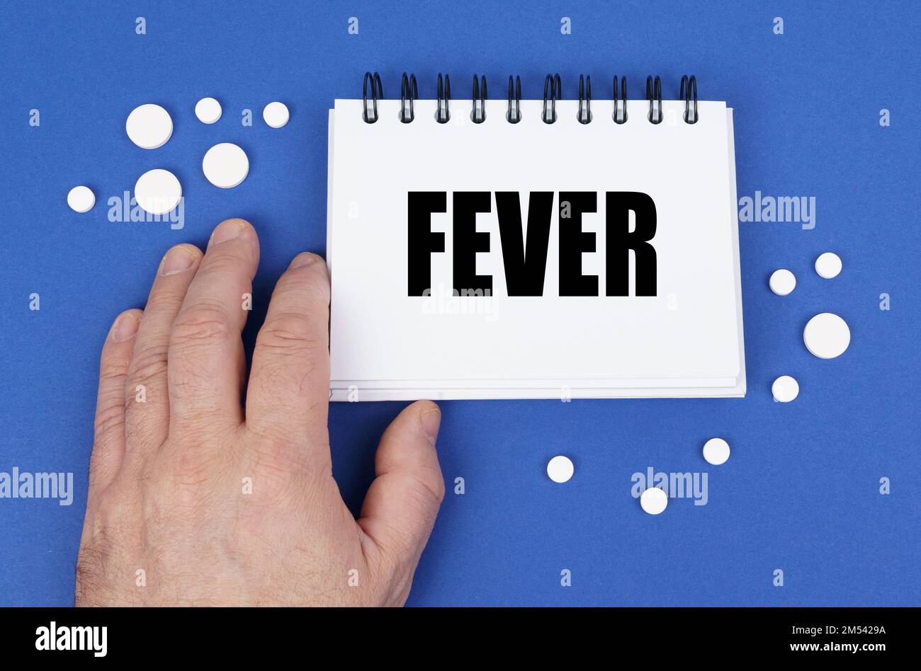 Medical concept. On the blue surface of the tablet, a hand and a ...