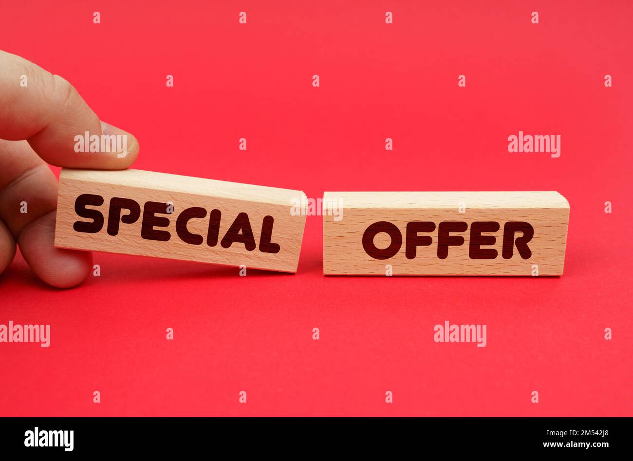 Business concept. On a red background, wooden blocks, one of them in ...
