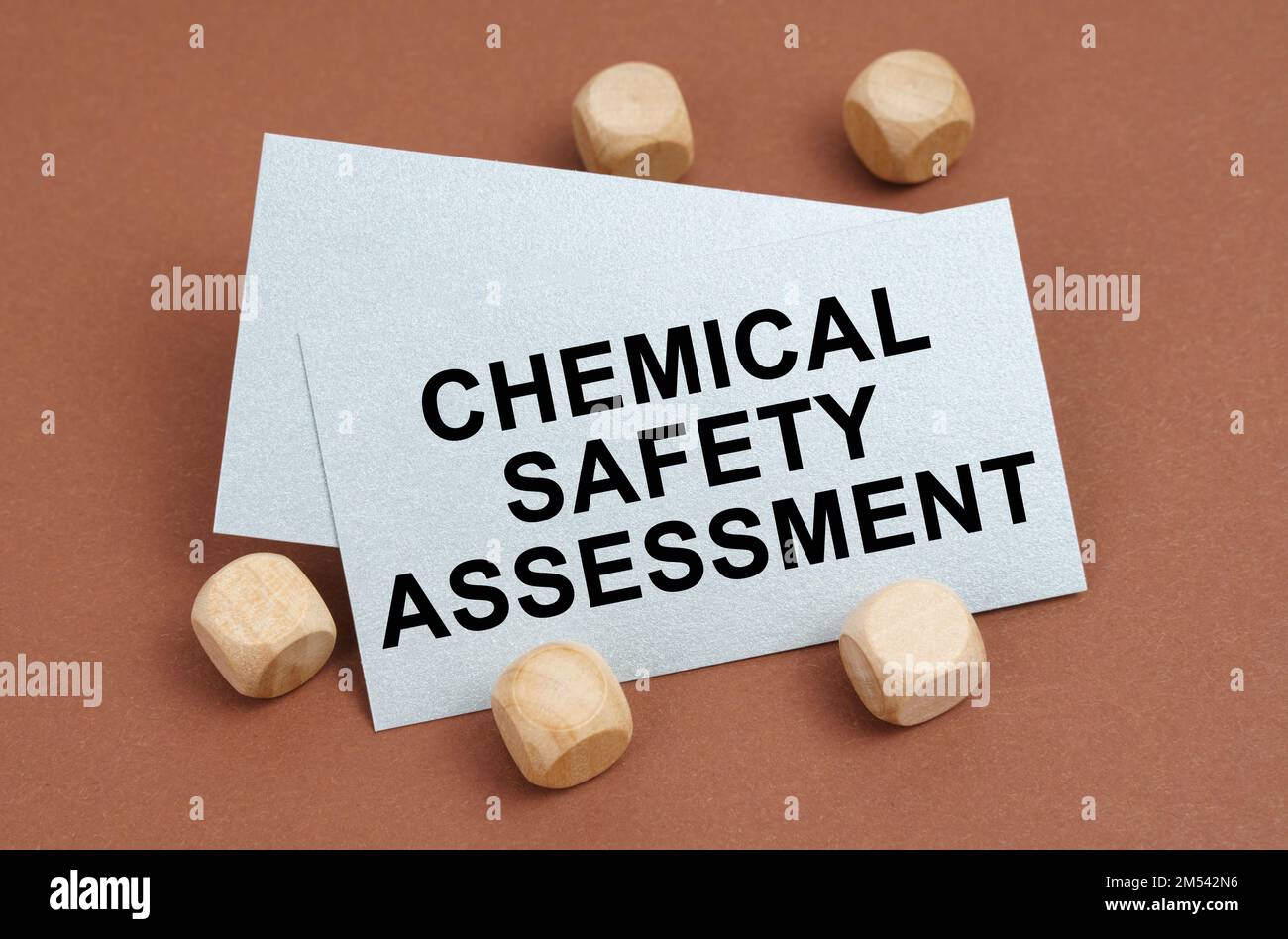 The concept of industrial safety. On a brown surface, wooden cubes and ...