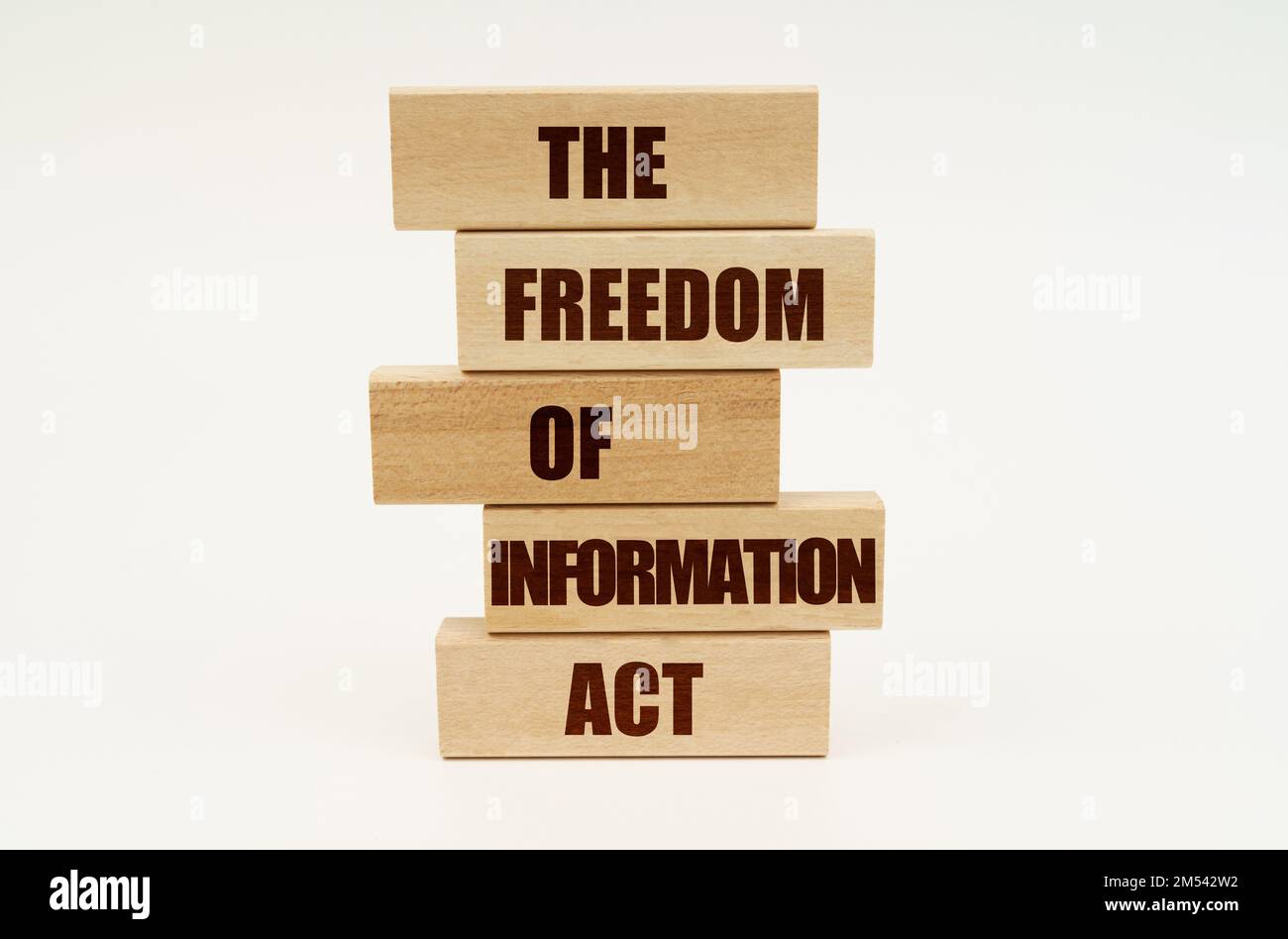 Business concept. On a white surface are wooden blocks with the ...