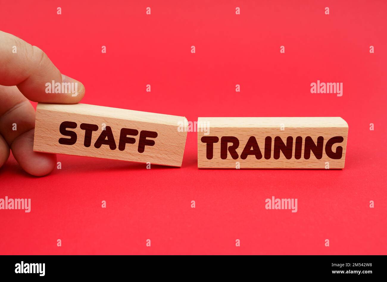 Business concept. On a red background, wooden blocks, one of them in ...