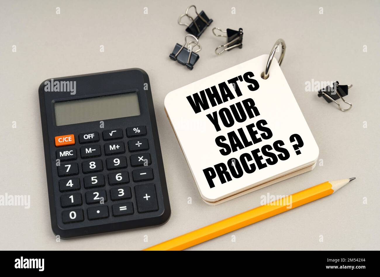 Business concept. On a gray surface, a calculator, a pencil and a ...