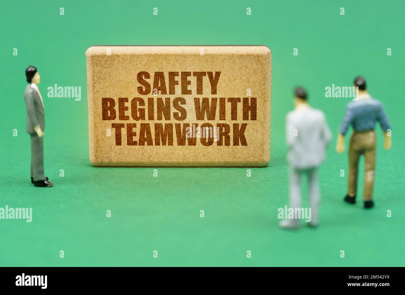 Security and insurance concept. On the green surface are figures of ...