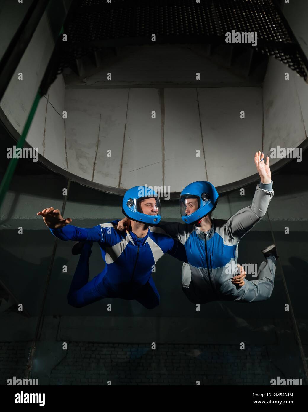 A man and a woman enjoy flying together in a wind tunnel. Free fall ...