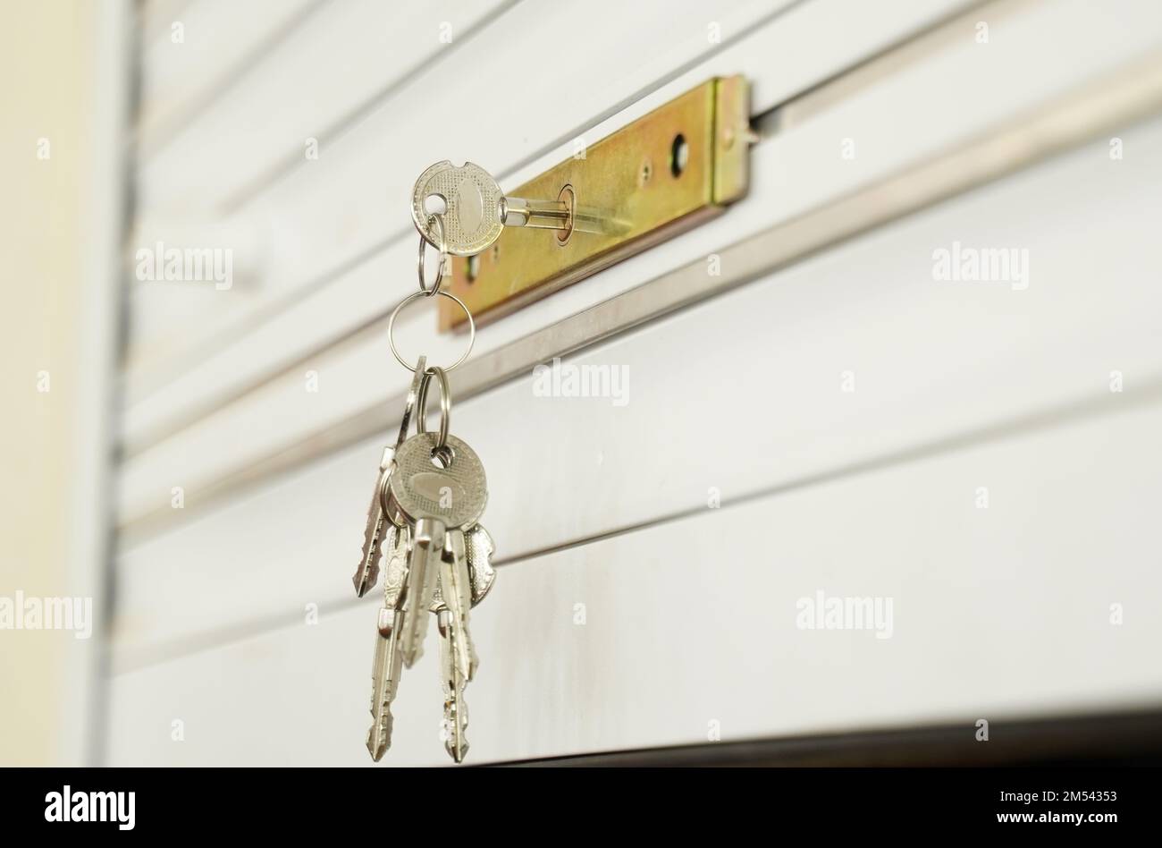 Keys in the lock section of the cabinet. Side view Stock Photo - Alamy