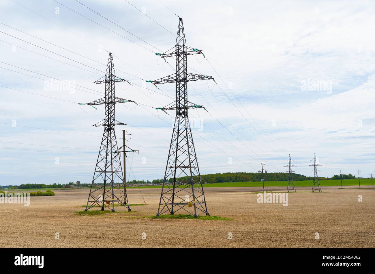 Industrial concept. Towers and high-voltage power lines in the field ...