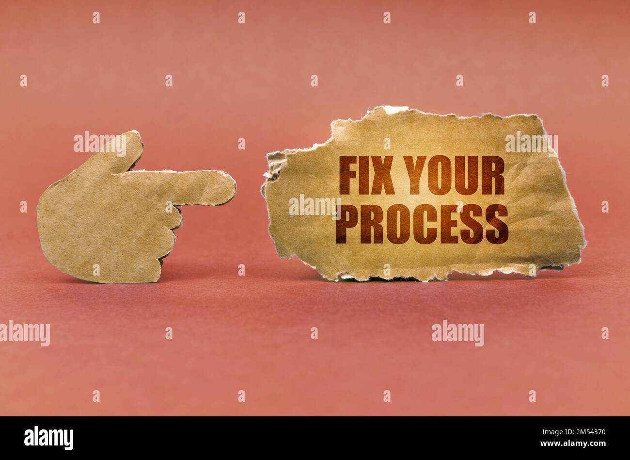 Business and technology concept. On a brown surface, a cardboard hand ...