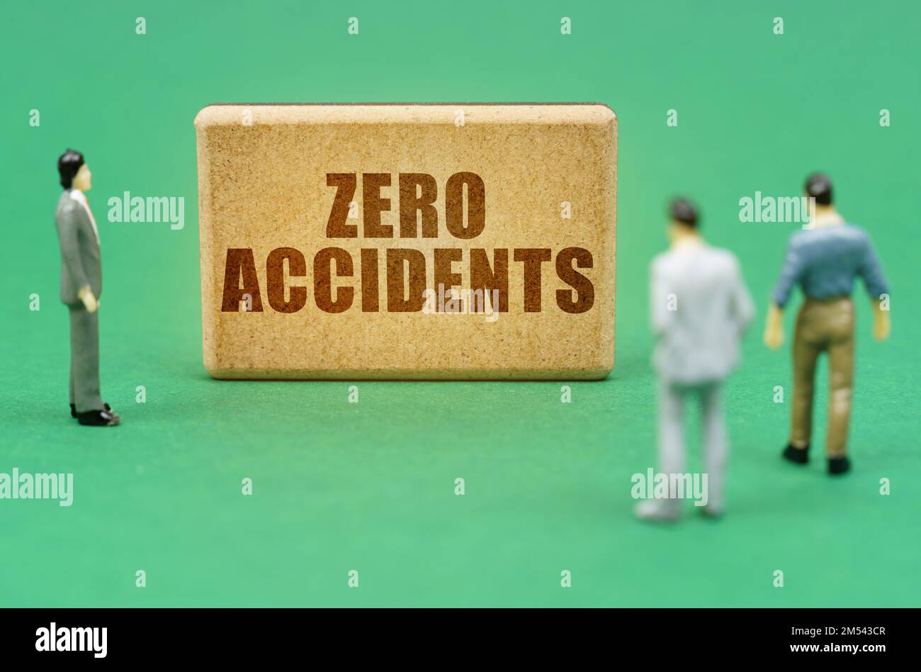 Security and insurance concept. On the green surface are figures of ...