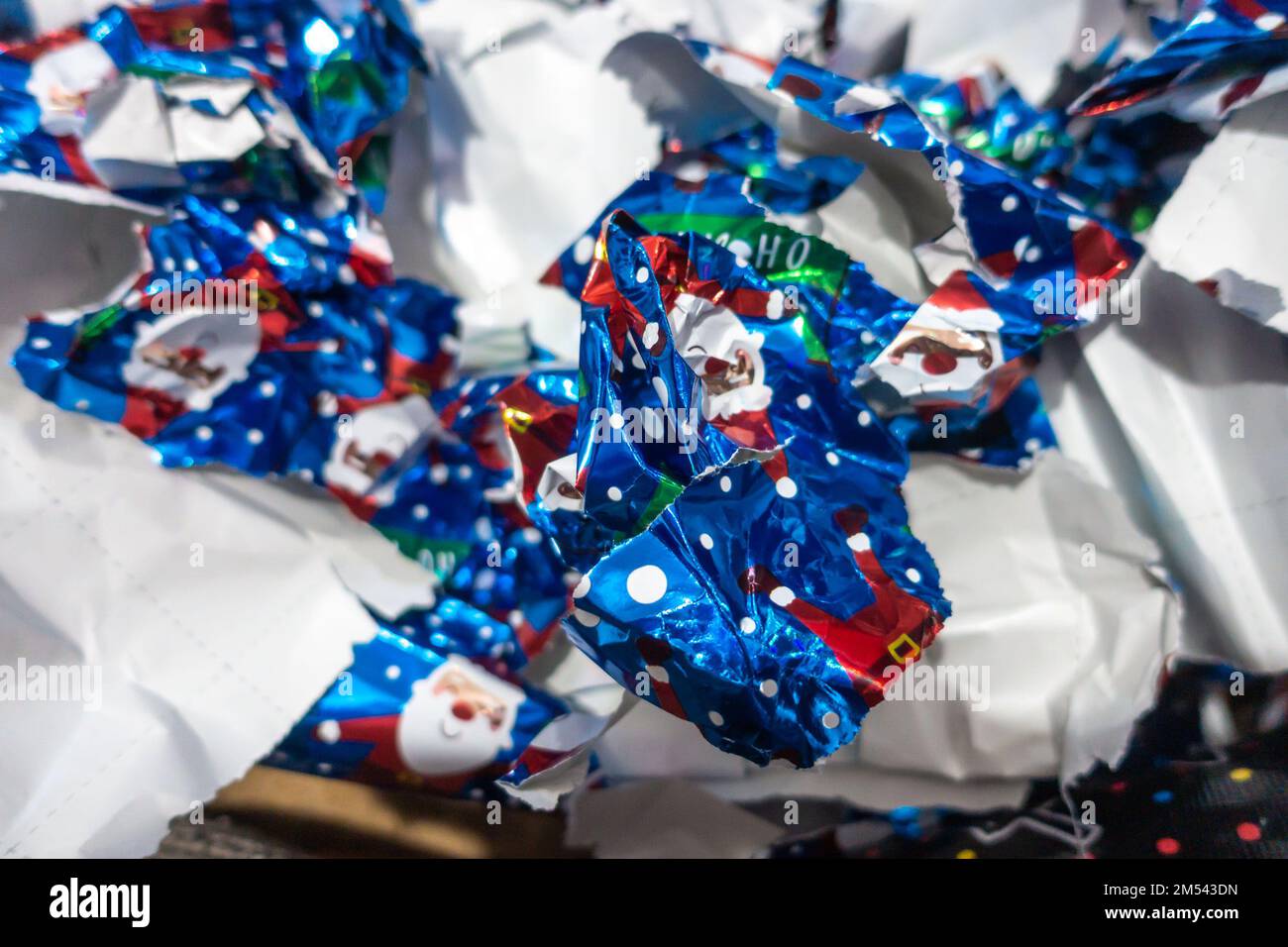Discarded Christmas wrapping paper thrown in a big pile on the floor ...