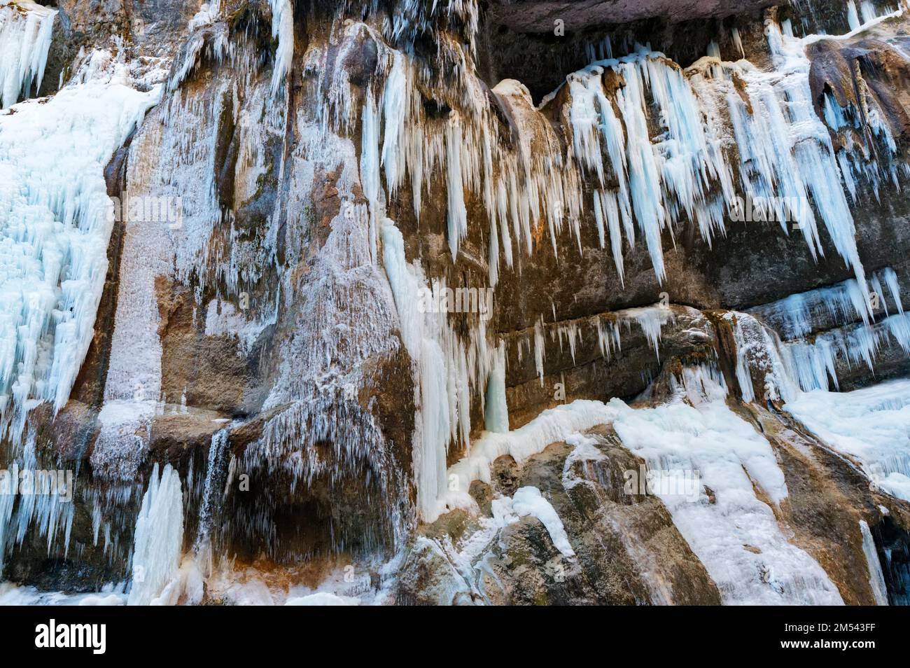 A frozen waterfall with ice in a blue and white color in winter Stock ...