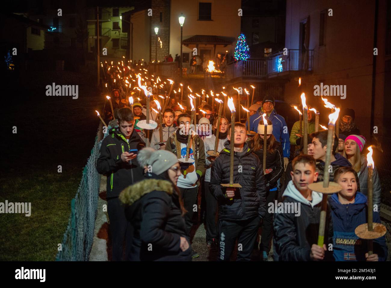 Serina Italy December 24 2022: People with torches walking towards the ...