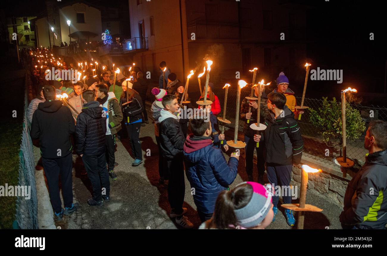 Serina Italy December 24 2022: People with torches walking towards the ...