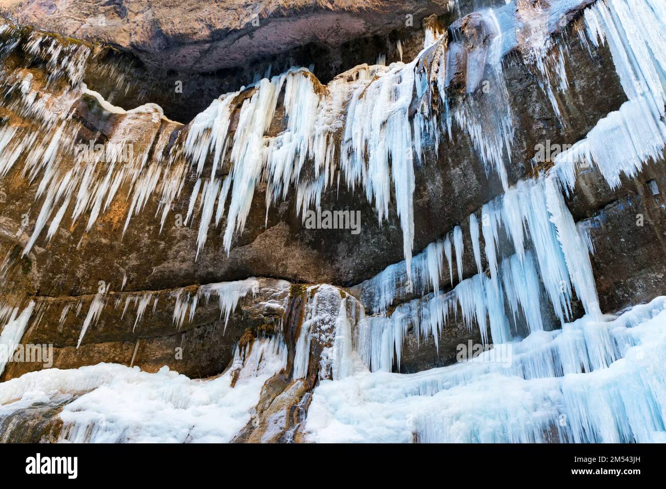 A frozen waterfall with ice in a blue and white color in winter Stock ...