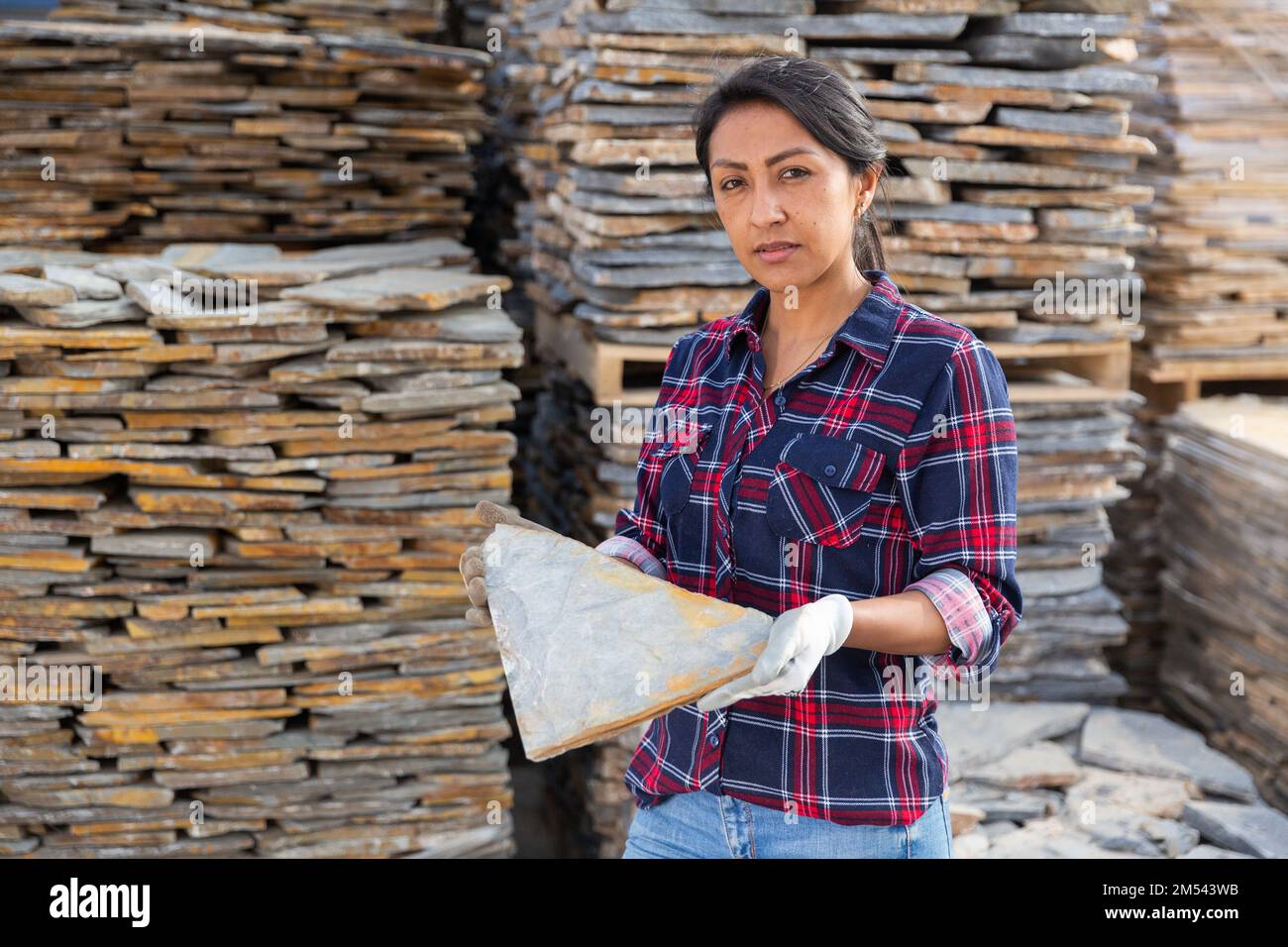 Buyer chooses natural facing stone at an open-air site Stock Photo - Alamy