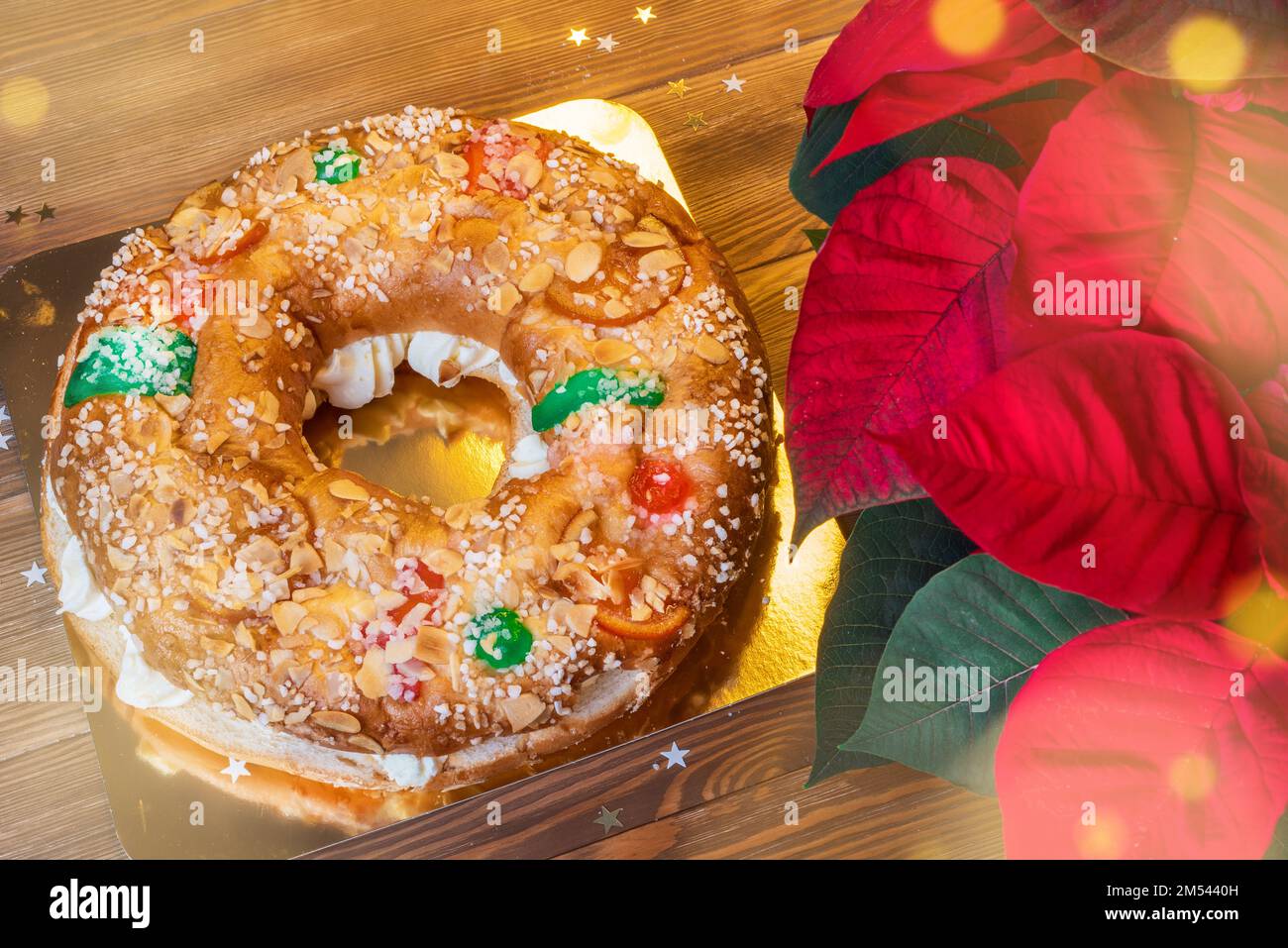 Epiphany cake "Roscon de Reyes" with a red poinsettia. Typical Spanish ...