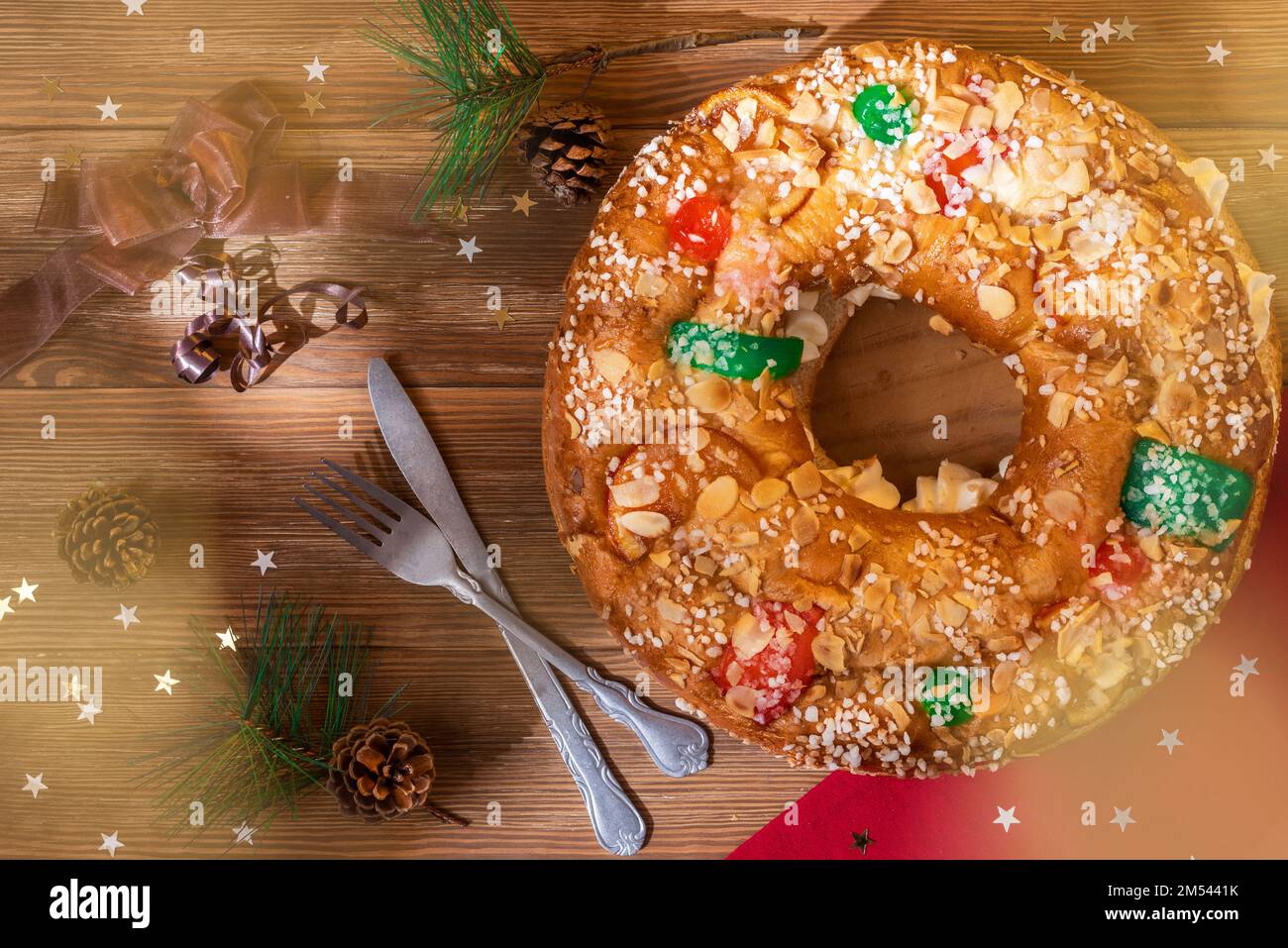 Epiphany cake "Roscon de Reyes" on a wooden table. Typical Spanish ...