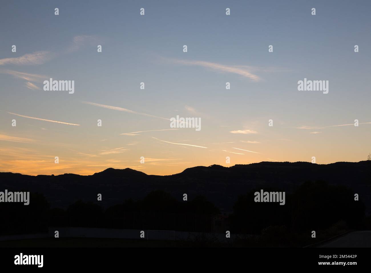sky streaked by aircraft trails at dusk in the autumn season Stock ...