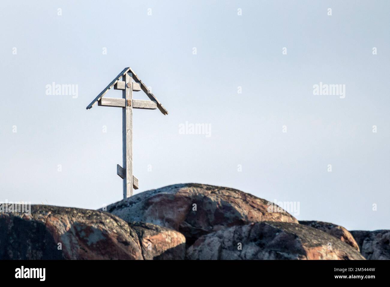 Religious Cross installed on a rock near a sea shore Stock Photo - Alamy