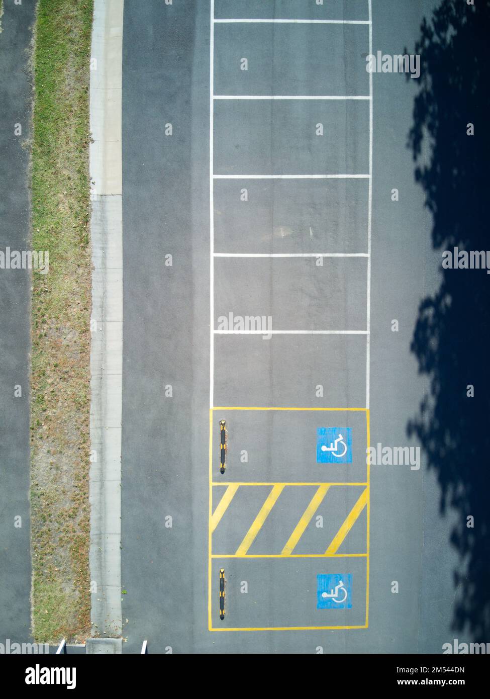 Handicapped parking space aerial view with yellow lines and asphalt ... Handicapped parking space aerial view with yellow lines and asphalt ...