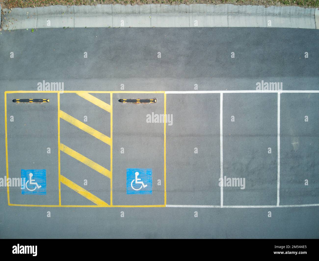 Handicapped parking space aerial view with yellow lines and asphalt ... Handicapped parking space aerial view with yellow lines and asphalt ...
