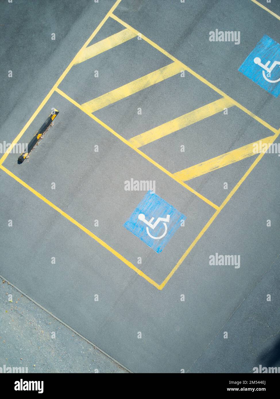 Disabled parking space aerial view with yellow lines and asphalt ... Disabled parking space aerial view with yellow lines and asphalt ...