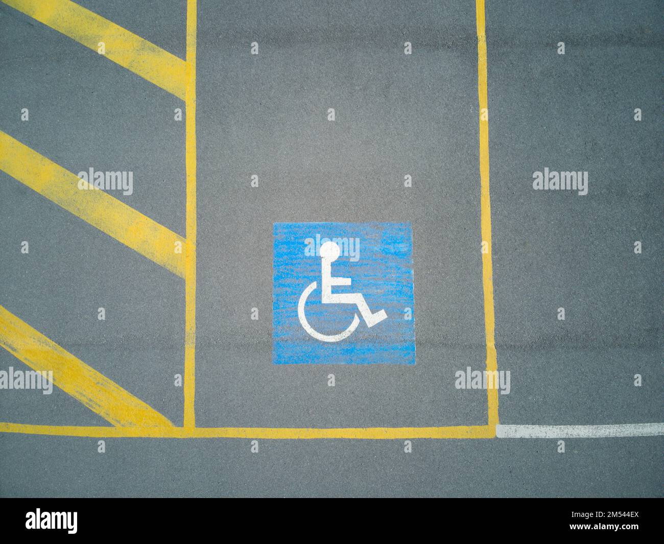 Handicapped parking space aerial view with yellow lines and asphalt ... Handicapped parking space aerial view with yellow lines and asphalt ...